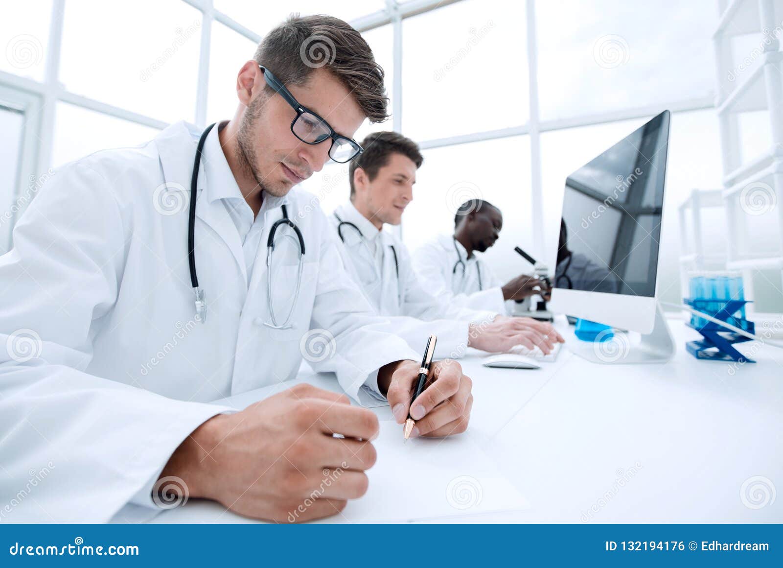 Group of Scientists Sitting at the Laboratory Table Stock Photo - Image ...