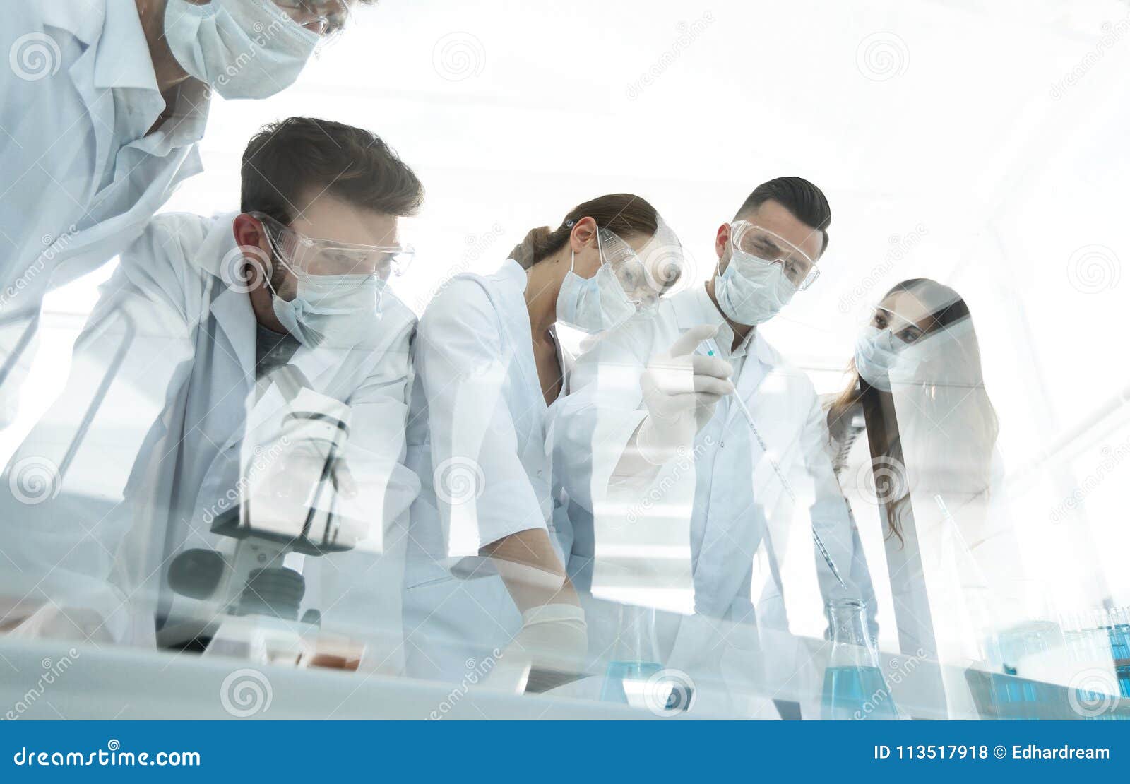 Scientists Working with Test Tubes and Microscope in the Laboratory ... Scientists Working with Test Tubes and Microscope in the Laboratory ...