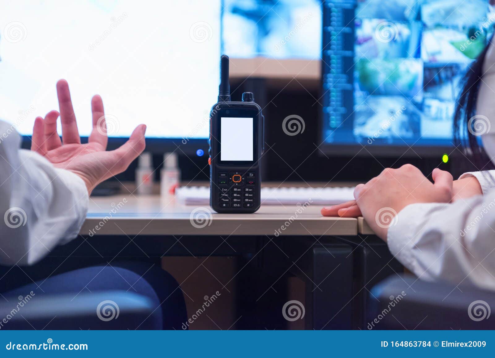 Group of Security Guards Working on Computers while Sitting in the Main ...