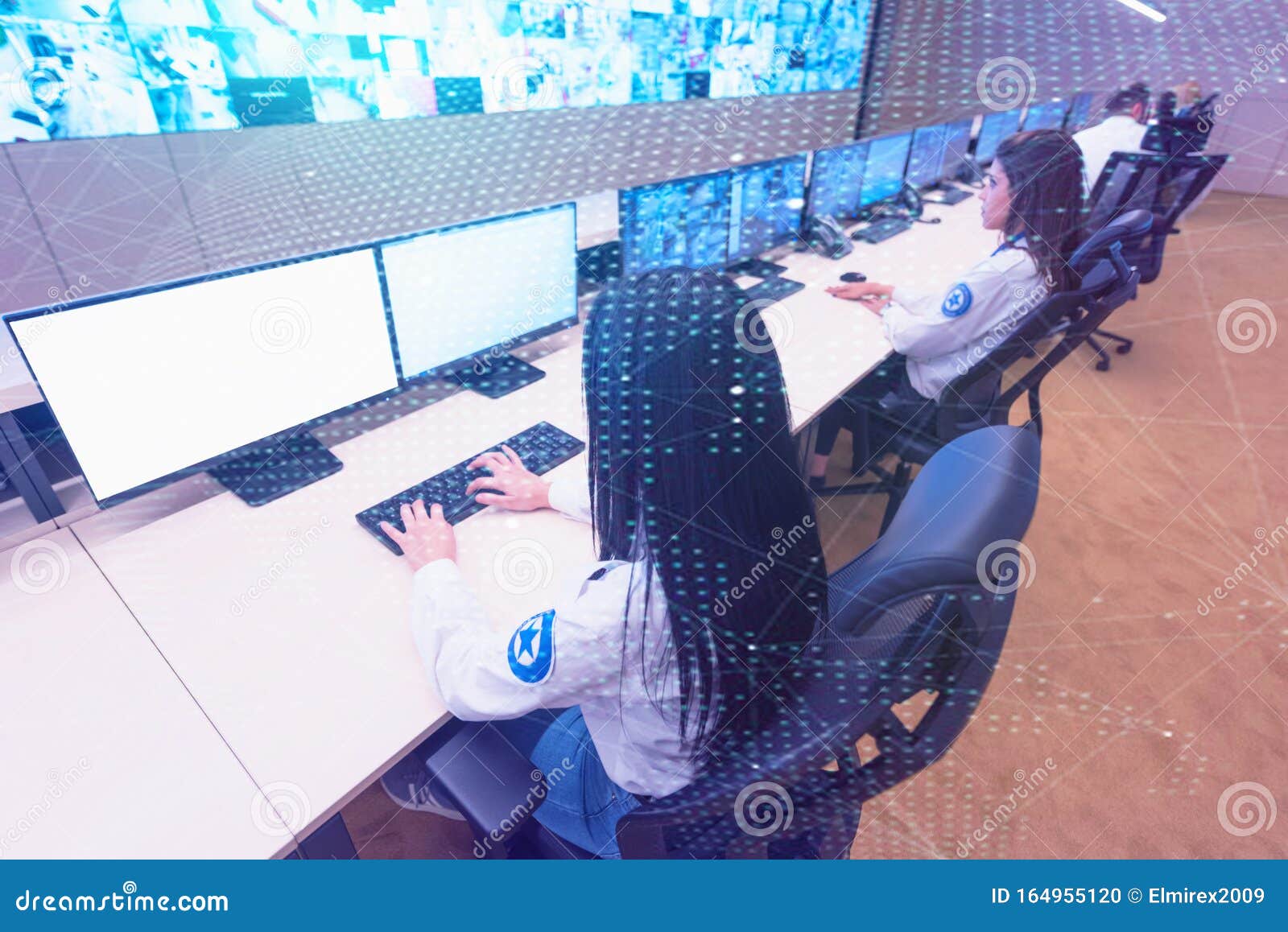 Group of Security Guards Working on Computers while Sitting in the Main ...