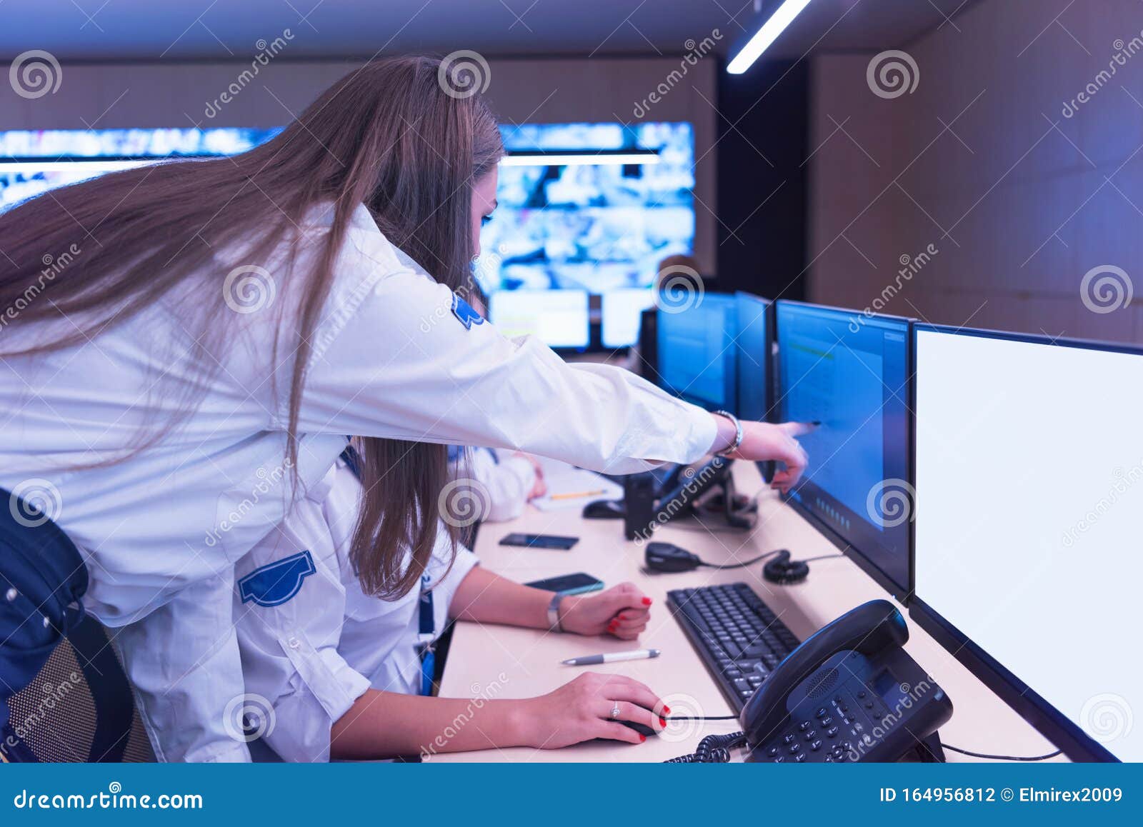 Group of Security Guards Working on Computers while Sitting in the Main ...