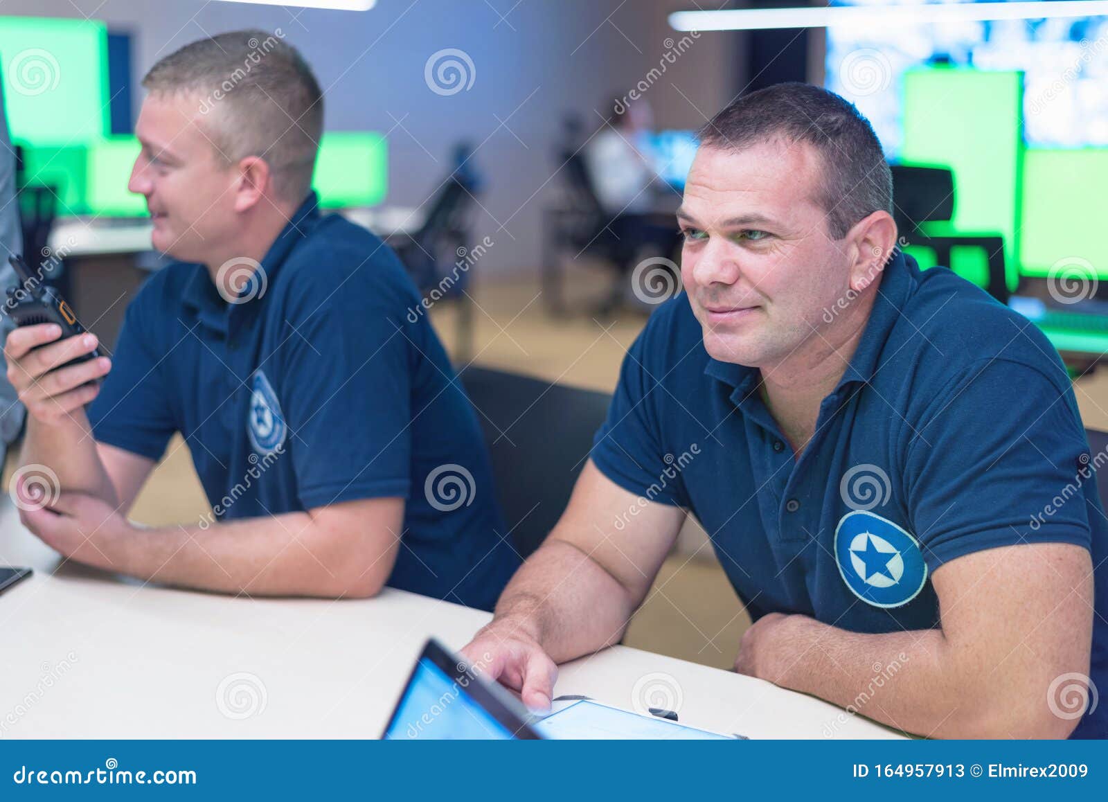 Group of Security Guards Working on Computers while Sitting in the Main ...