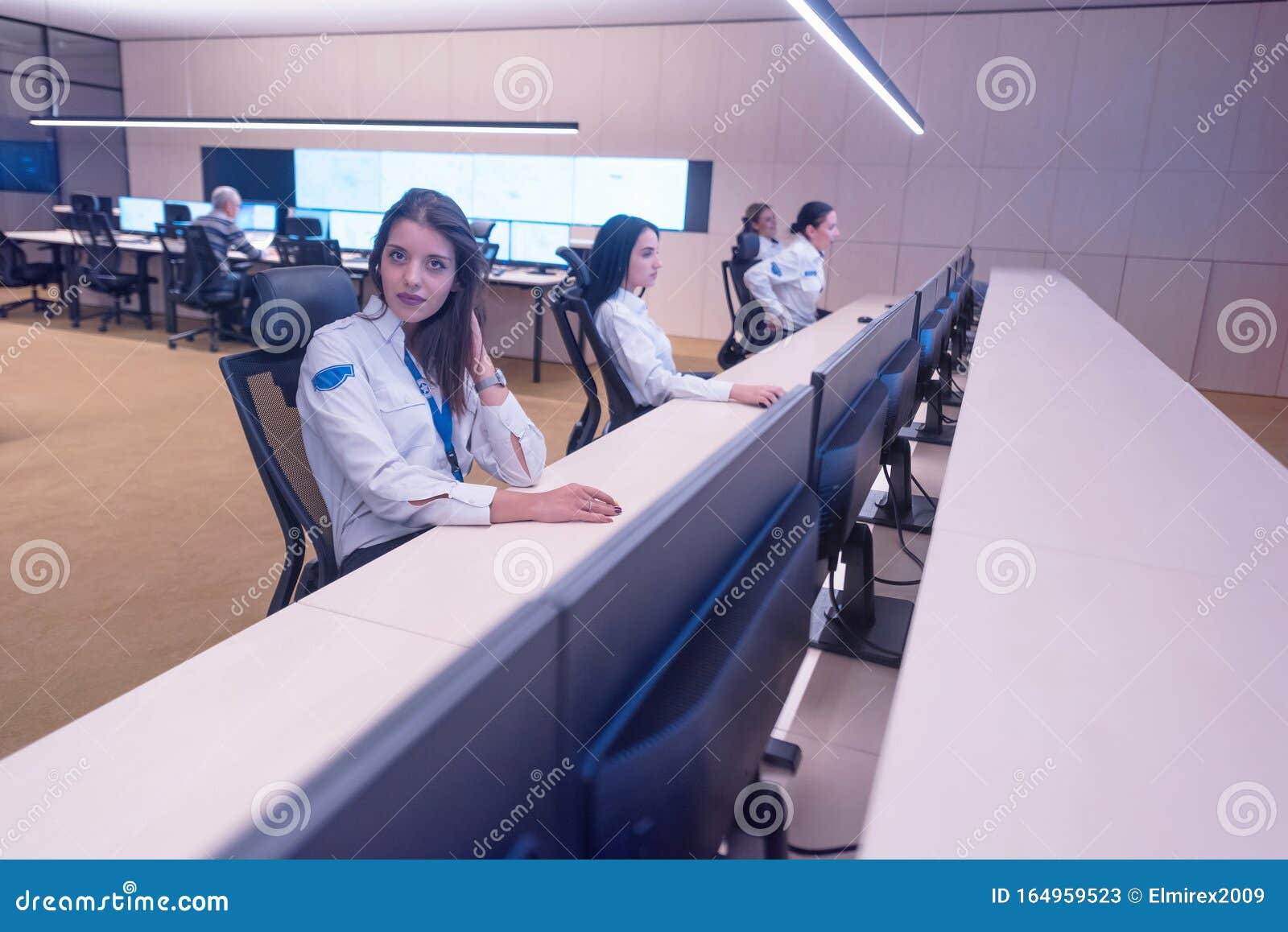 Group of Security Guards Working on Computers while Sitting in the Main ...
