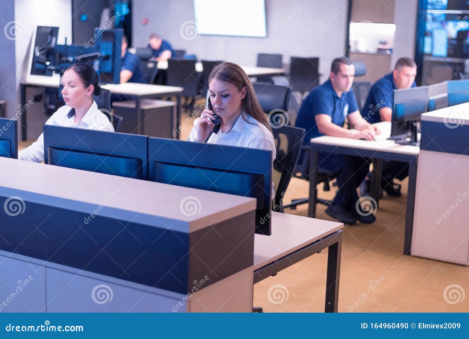 Group of Security Guards Working on Computers while Sitting in the Main ...