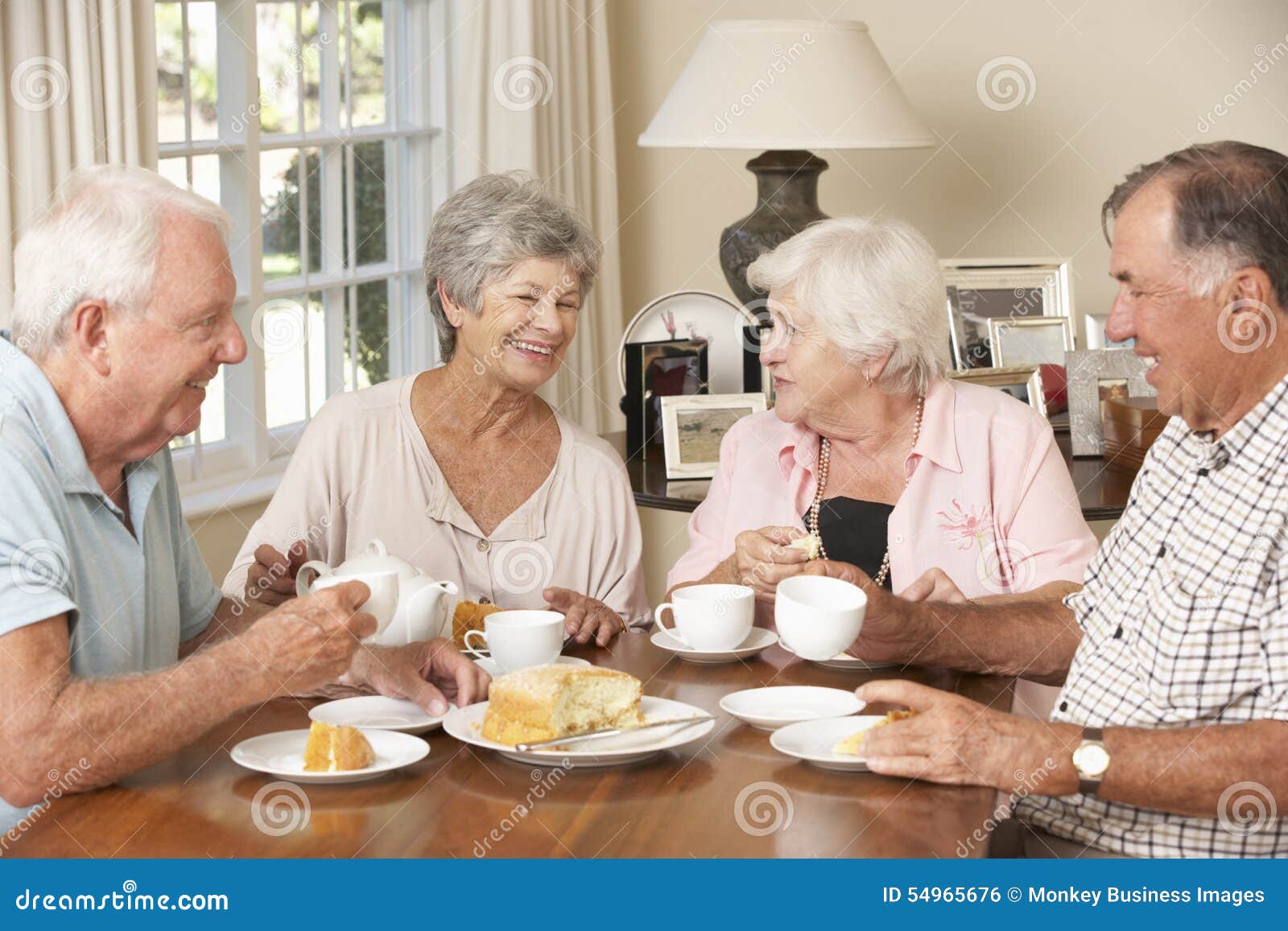 Group of Senior Couples Enjoying Afternoon Tea Together at Home Stock ...