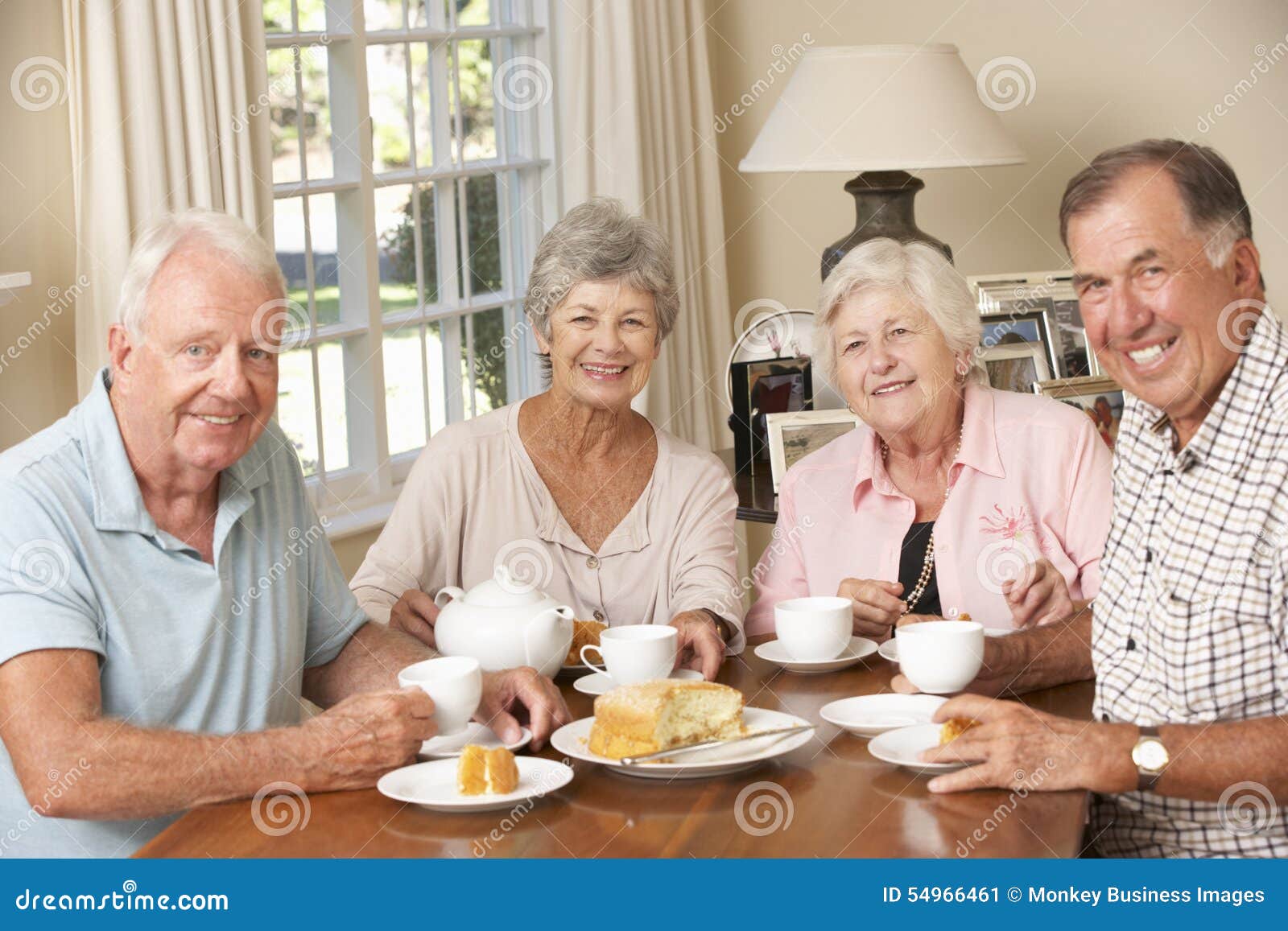 Group of Senior Couples Enjoying Afternoon Tea Together at Home Stock ...