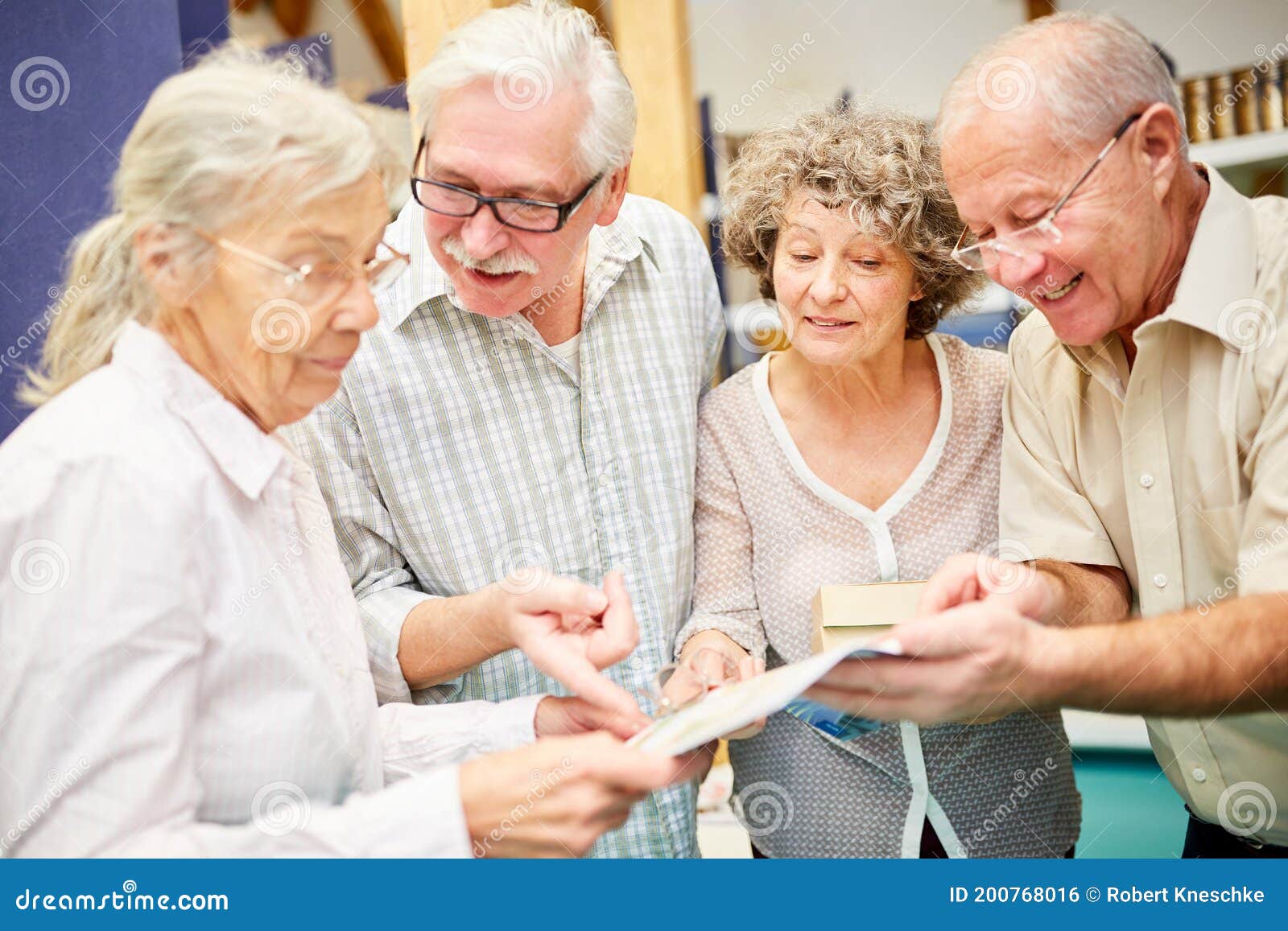 Group of Seniors with Book Researching As a Team Stock Photo - Image of ...