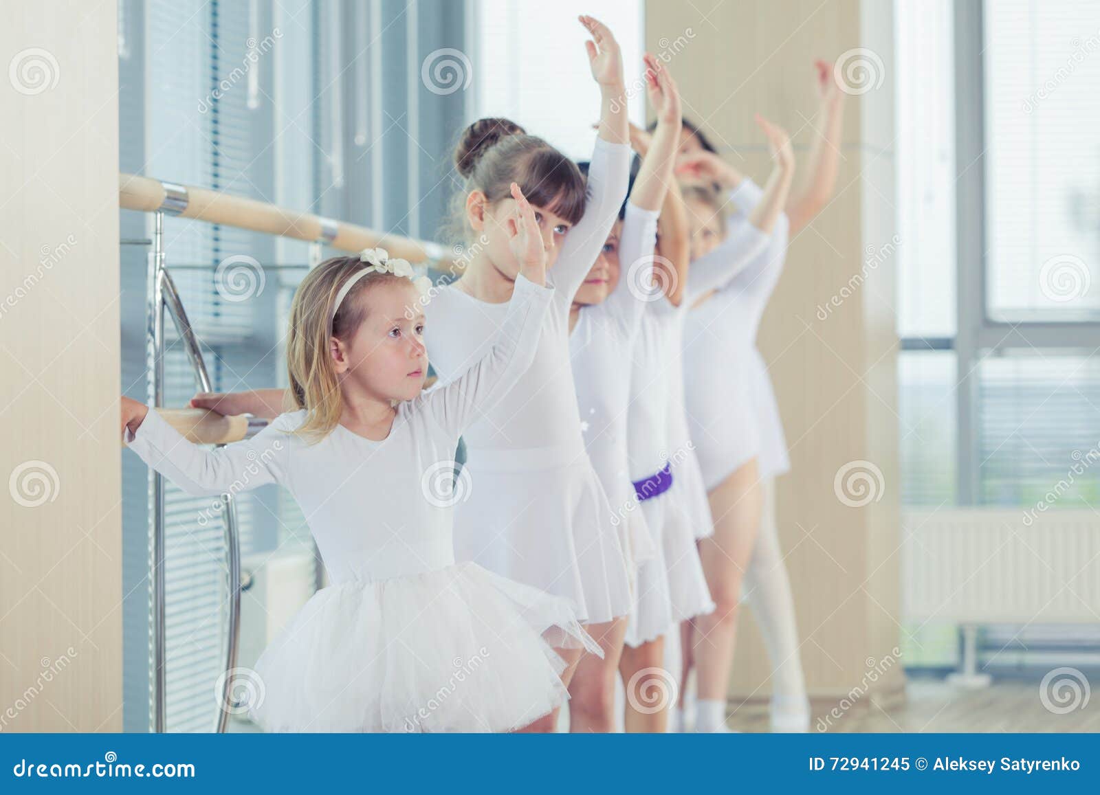 Group of Seven Little Ballerinas Standing in Row and Practicing Ballet ...