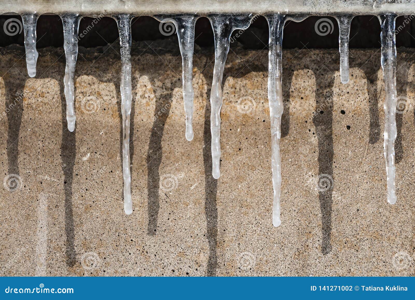 A Group of Sharp White Transparent Icicles with Shadows is Hanging Down ...