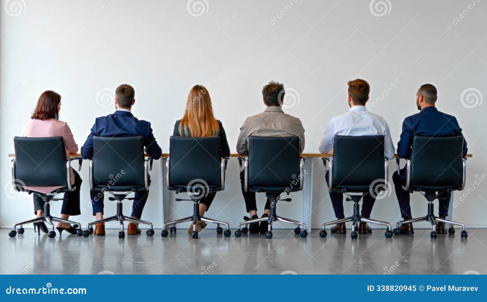 Group of Six Professionals Seated in Row Facing Wall Waiting for ...