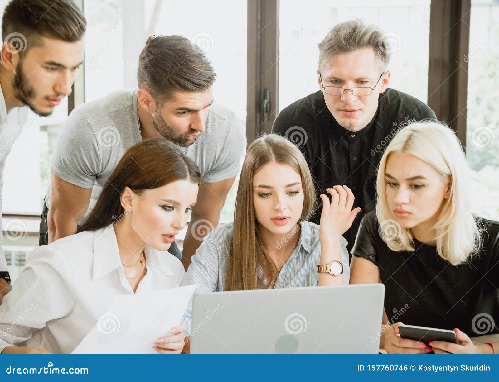 Group of Six Students with Drawings Schemes and Laptop is Working with ...