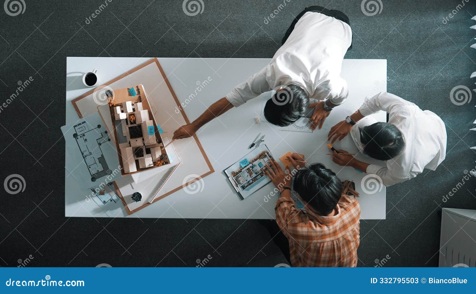 Group of Designer Look at Model while Discussing about Building ...