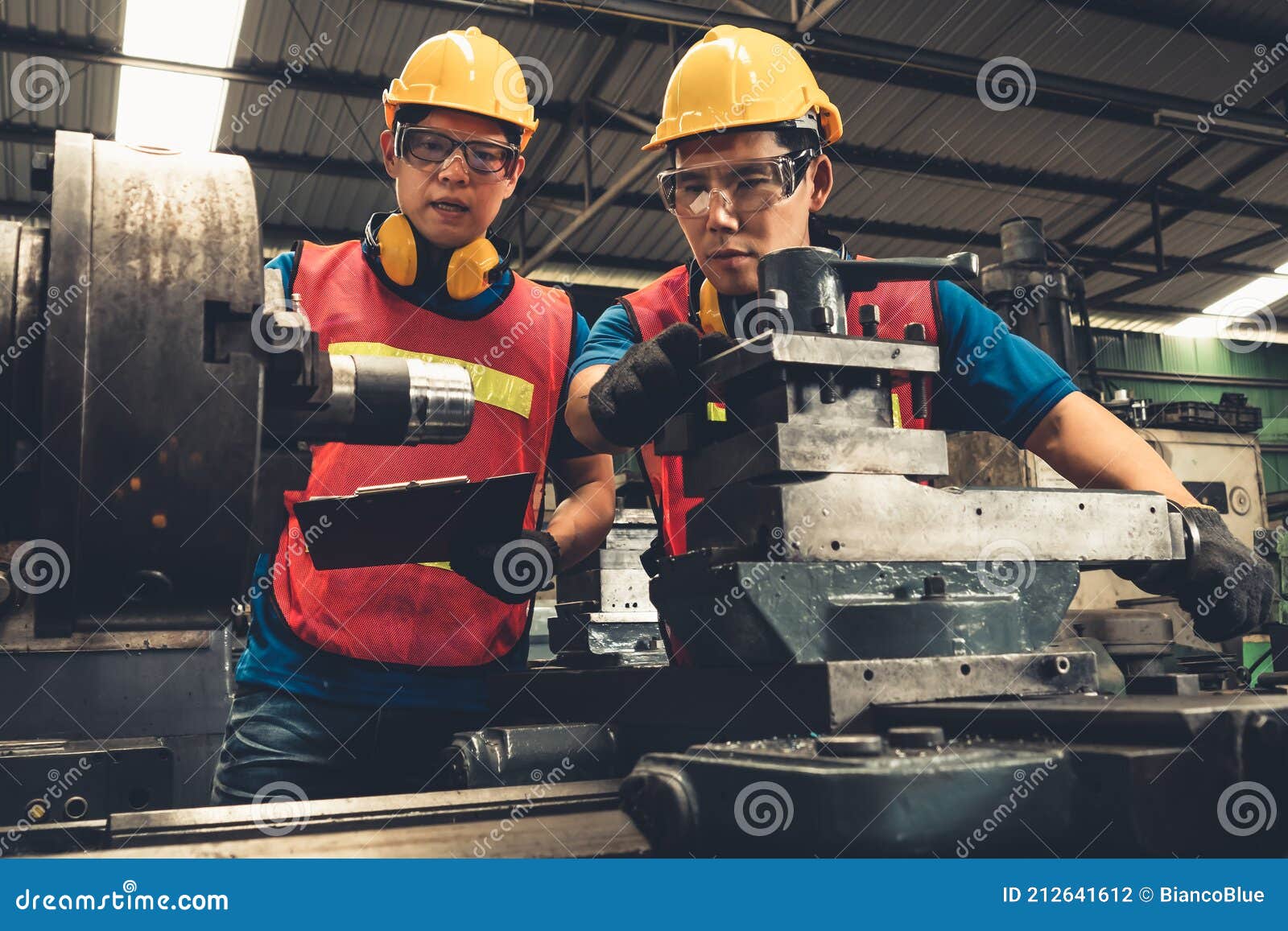 Group of Skillful Factory Workers Using Machine Equipment in Workshop ...