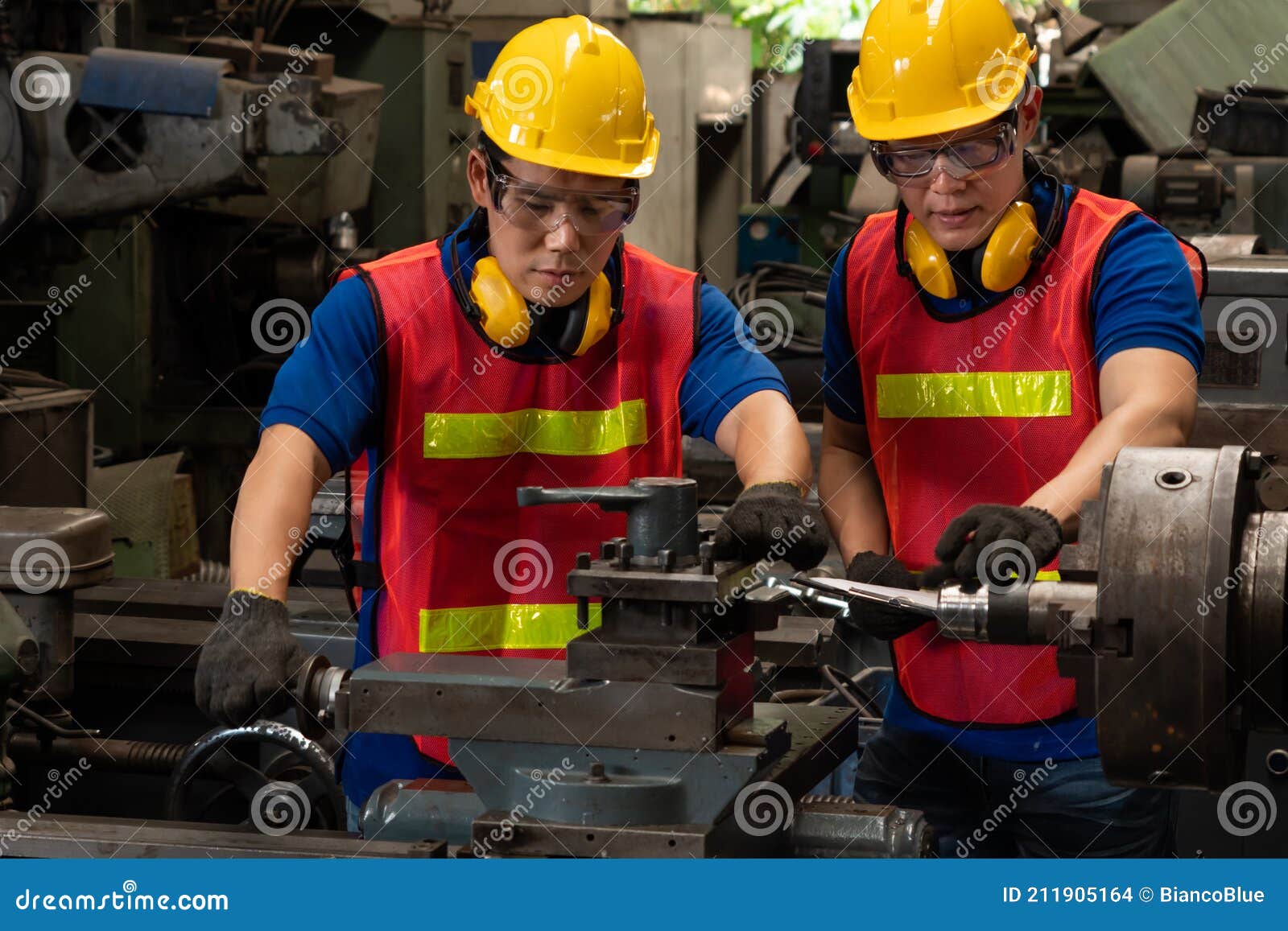 Group of Skillful Factory Workers Using Machine Equipment in Workshop ...