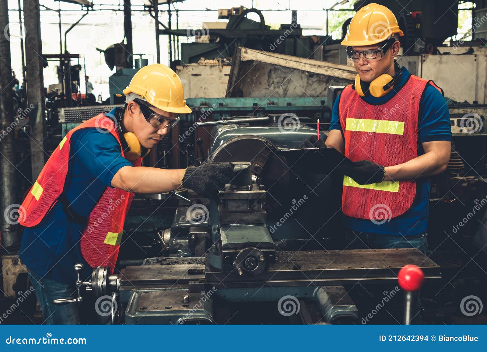 Group of Skillful Factory Workers Using Machine Equipment in Workshop ...