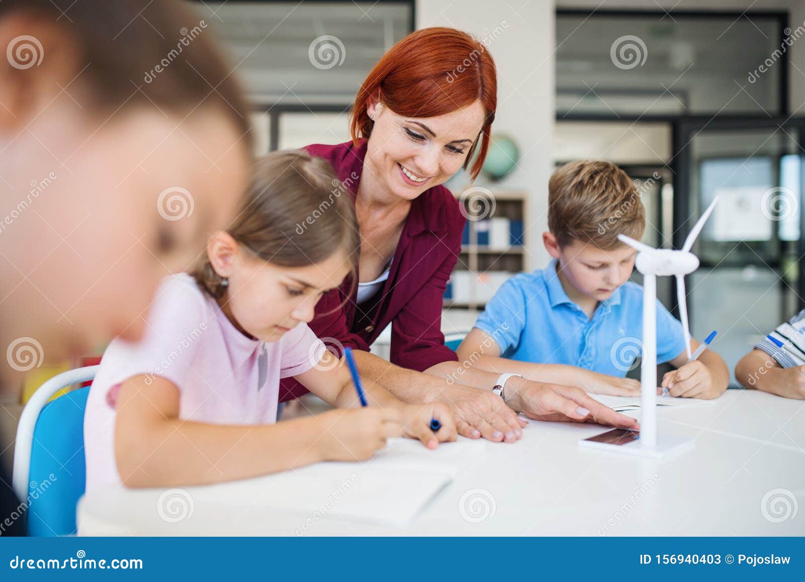 A Group of Small School Kids with Teacher in Class Learning about ...