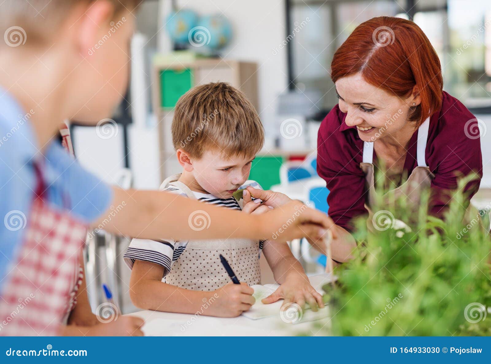Group of Small School Kids with Teacher in Class, Learning about Plants ...