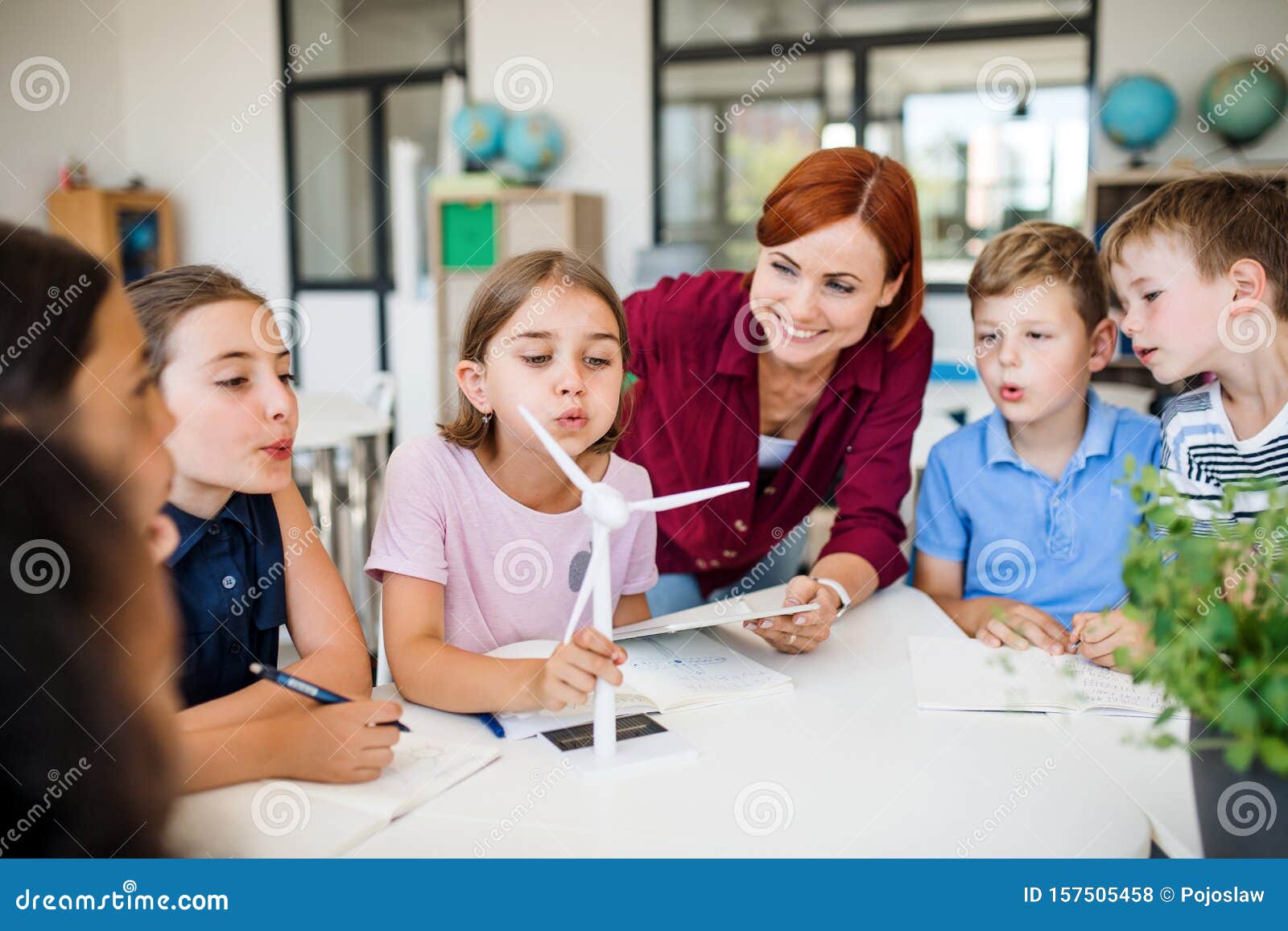 A Group of Small School Kids with Teacher in Class Learning about ...