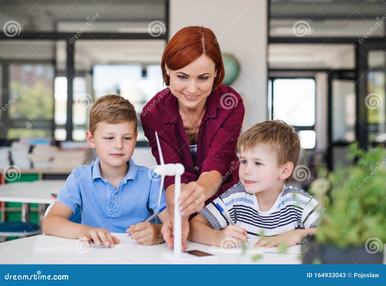 A Group of Small School Kids with Teacher in Class Learning about ...