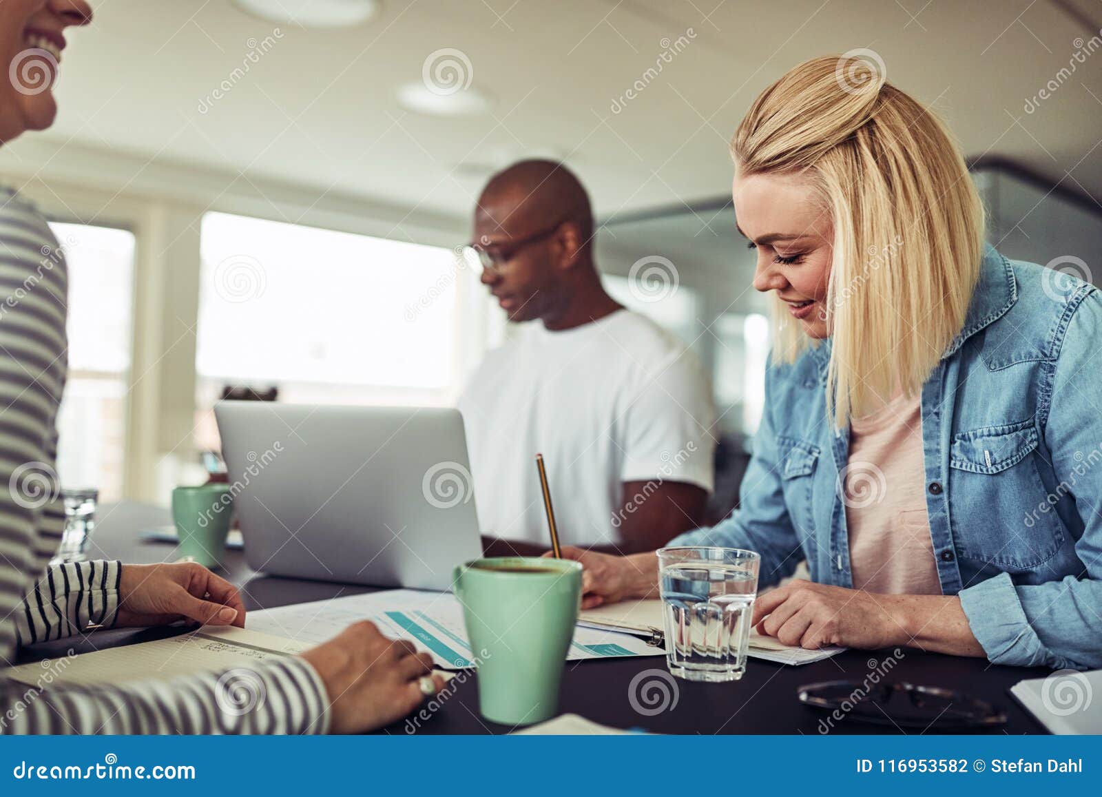 Group of Smiling Business Colleagues Working Around an Office Ta Stock ... Group of Smiling Business Colleagues Working Around an Office Ta Stock ...