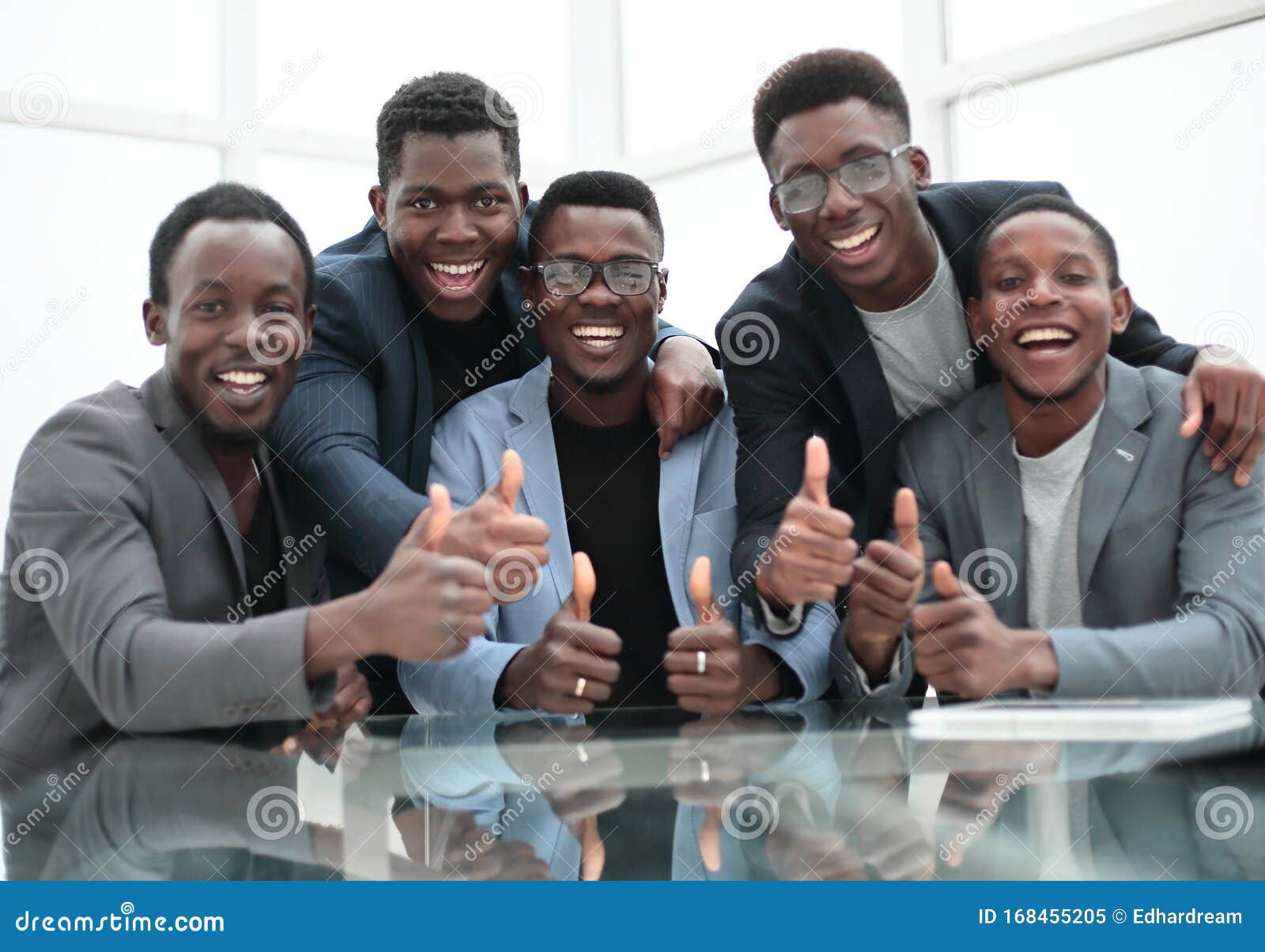 Group of Smiling Employees Giving a Thumbs Up Stock Image - Image of ...