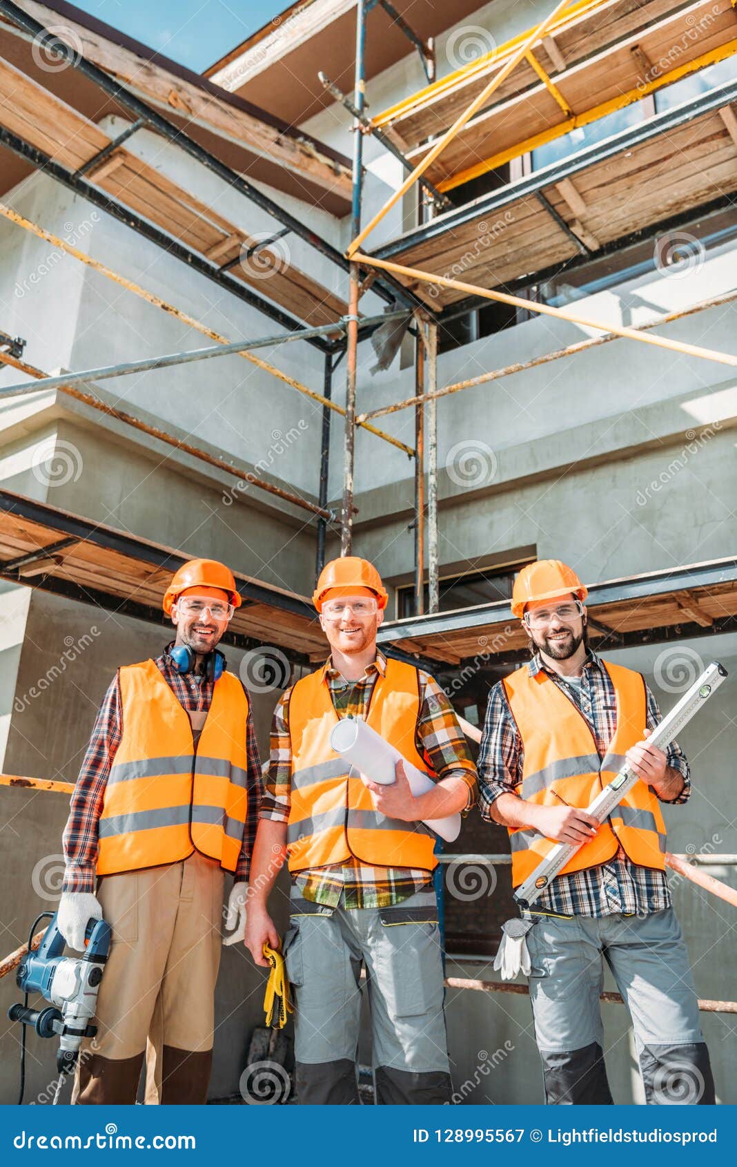 Group of Smiling Equipped Builders Looking at Camera Stock Image ...