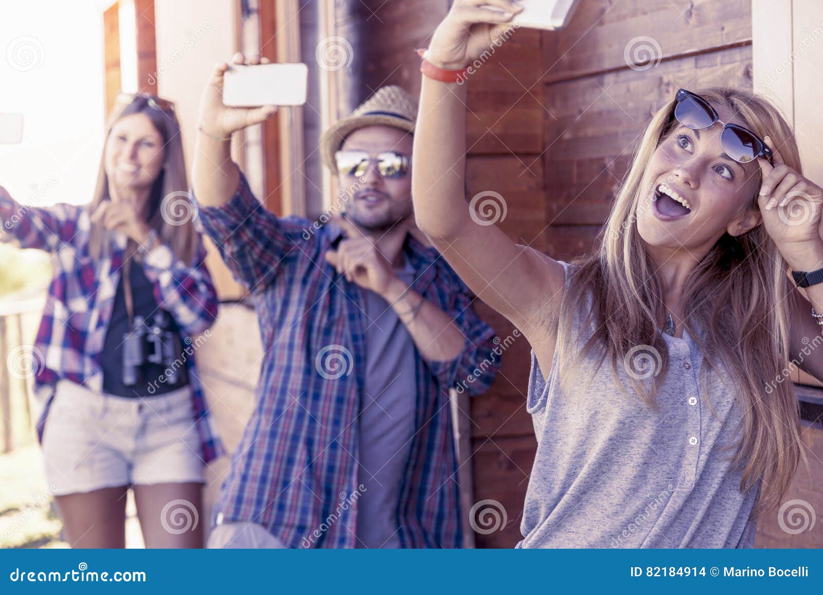 Group of Smiling Friends in Single File Taking Funny Selfie Stock Photo ...