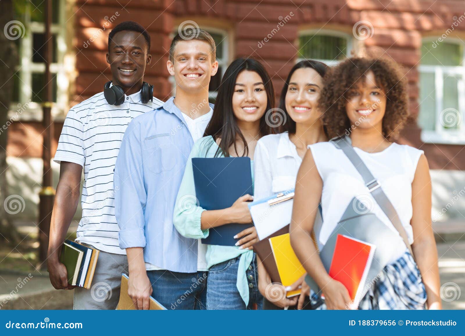 Group of Smiling Multicultural Students Posing Near University Campus ...