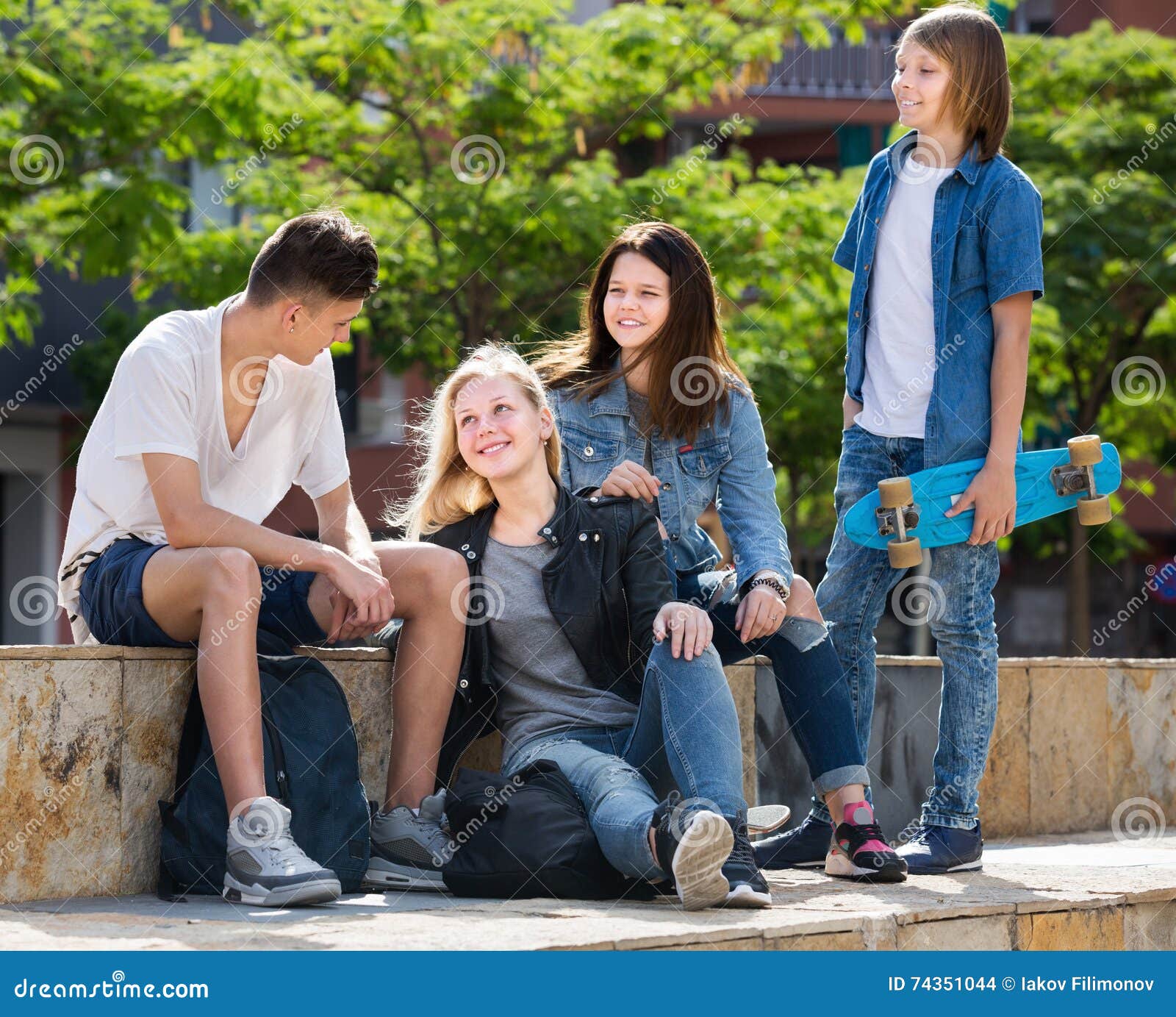 Group of Smiling Teenagers in Park on Summer Day Stock Photo - Image of ...