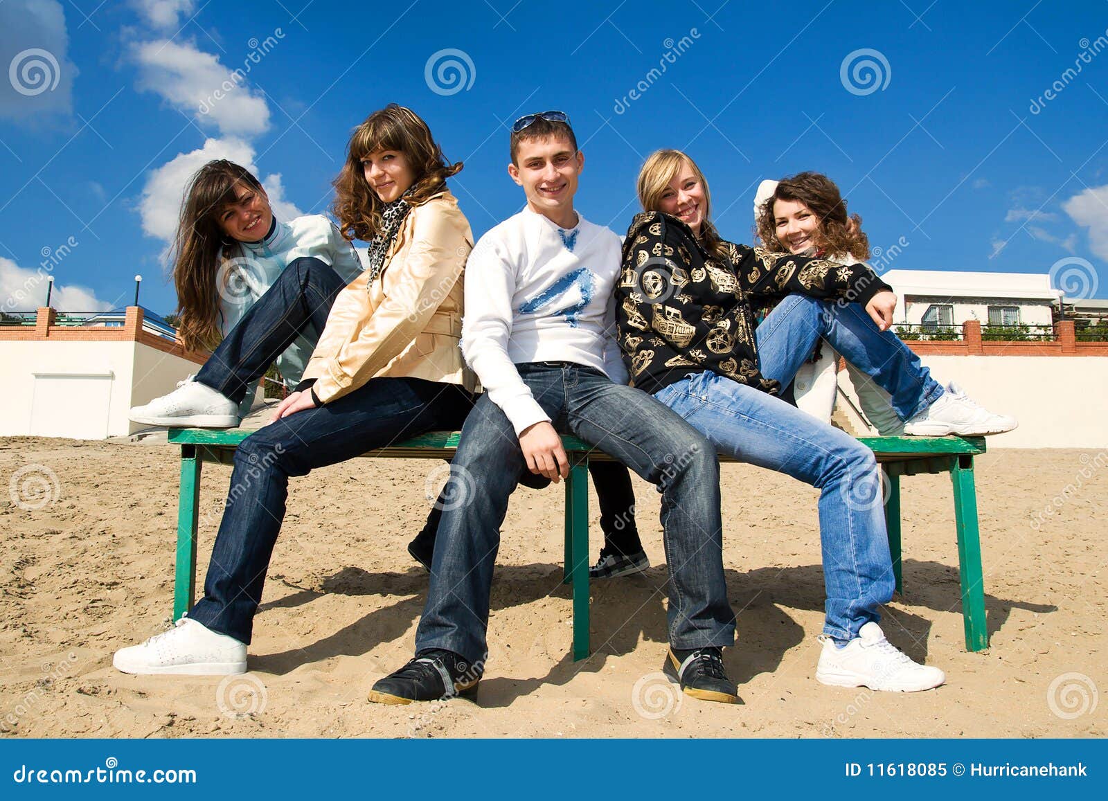 Group Smiling Teenagers Sitting on a Bench Stock Image - Image of ...