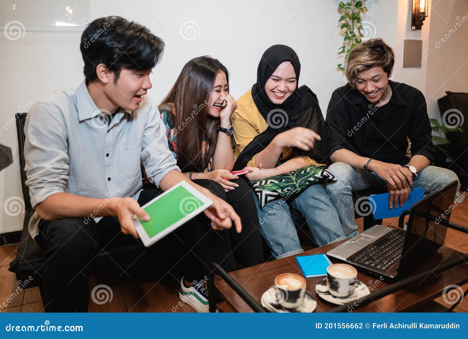 Group of Smiling Teenagers Staying Together Using Gadget Stock Photo ...
