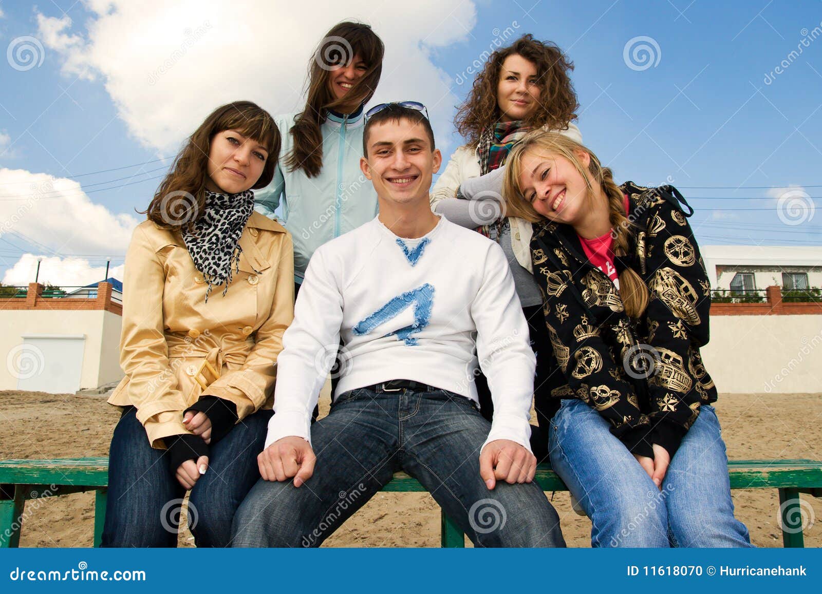 Group of Smiling Young People on a Bench Stock Photo - Image of colors ...