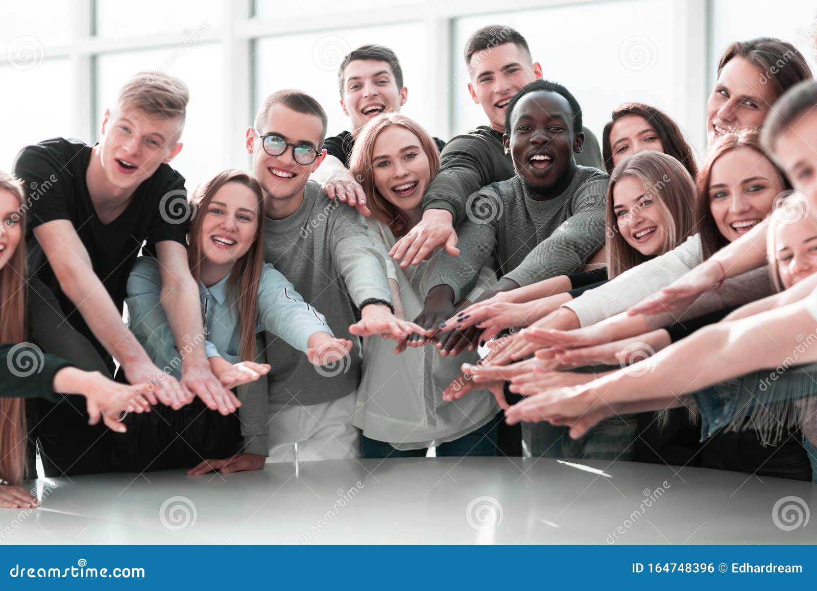 Group of Smiling Young People Joining Their Hands Stock Photo - Image ...