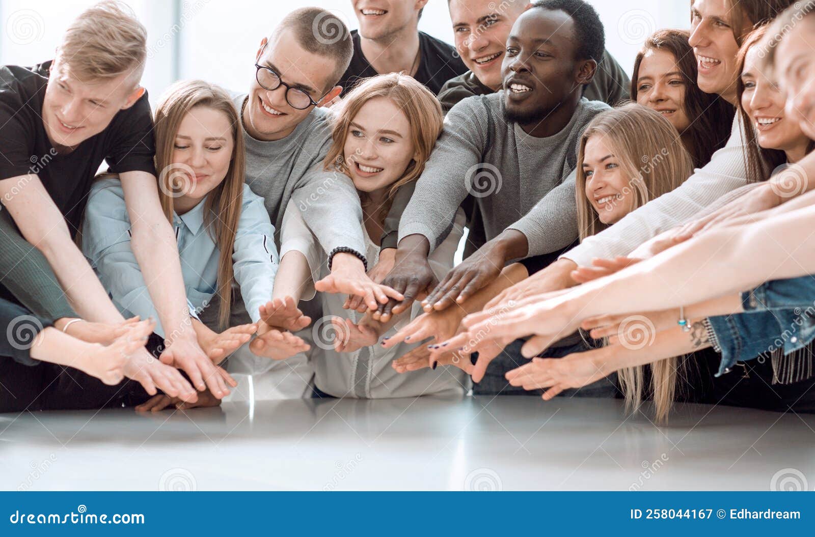 Group of Smiling Young People Joining Their Hands Stock Image - Image ...