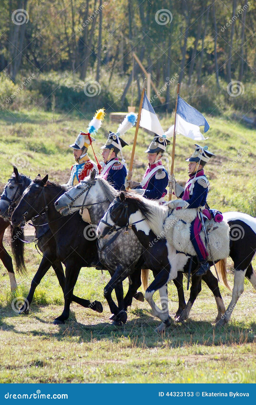 Group Of Soldiers-reenactors Ride Horses, Two Men Carry Flags ... Group Of Soldiers-reenactors Ride Horses, Two Men Carry Flags ...