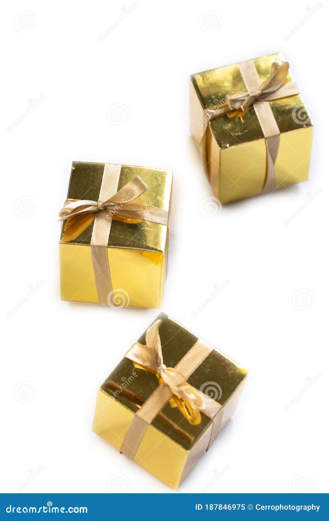 Group of Sparkling Gold Present or Gift Boxes in a Row with Bow ...