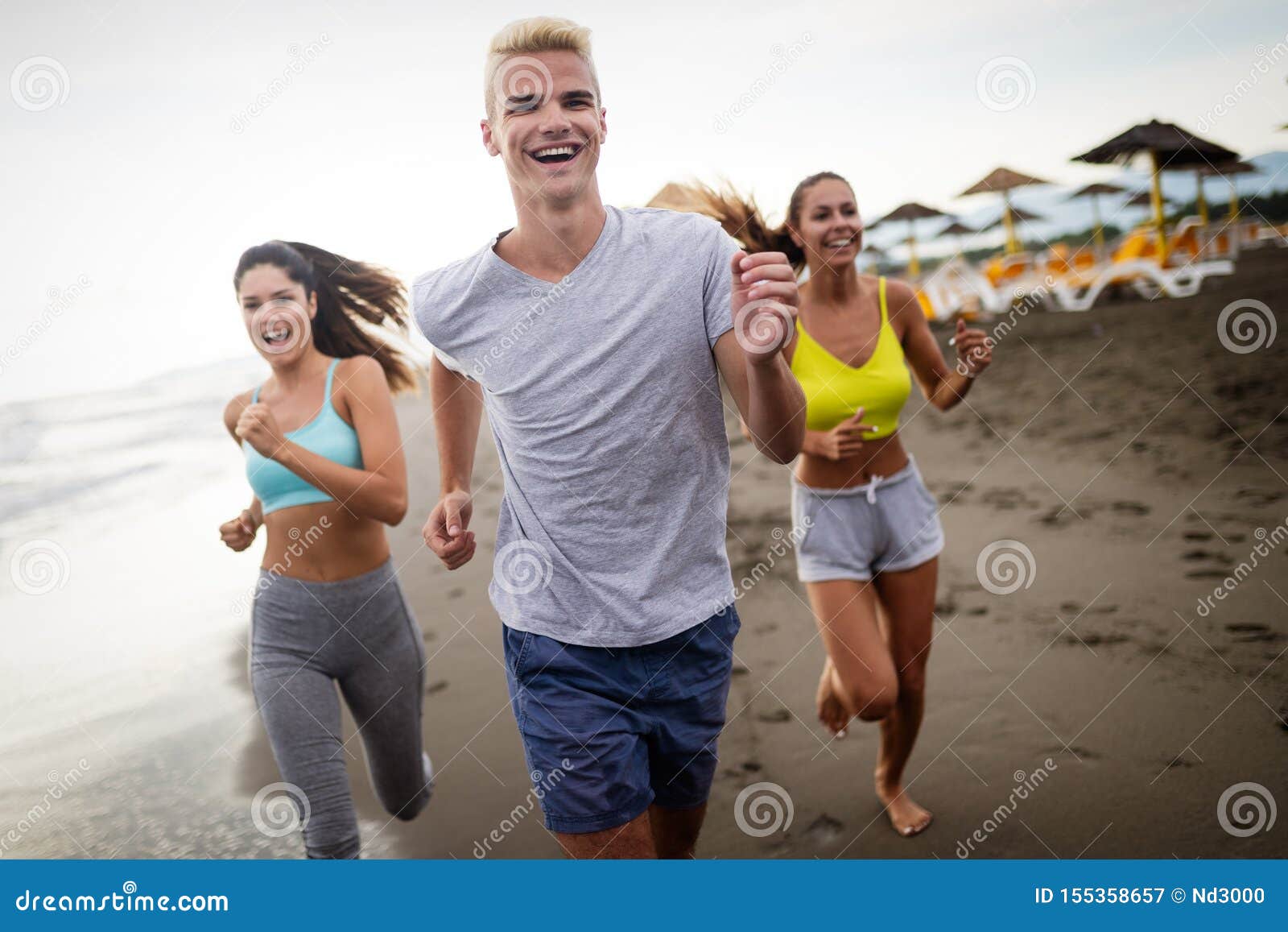 Group of Sport People Jogging on the Beach Stock Image - Image of ...