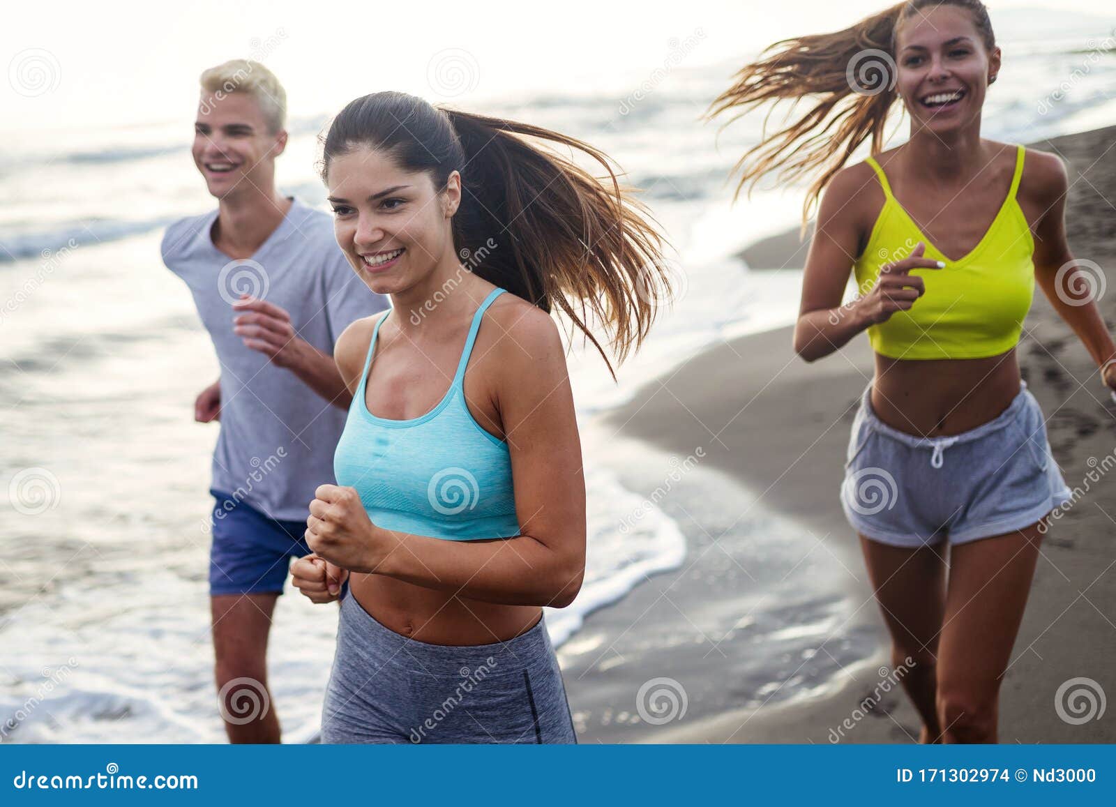 Group of Sport People Jogging on the Beach Stock Photo - Image of ...