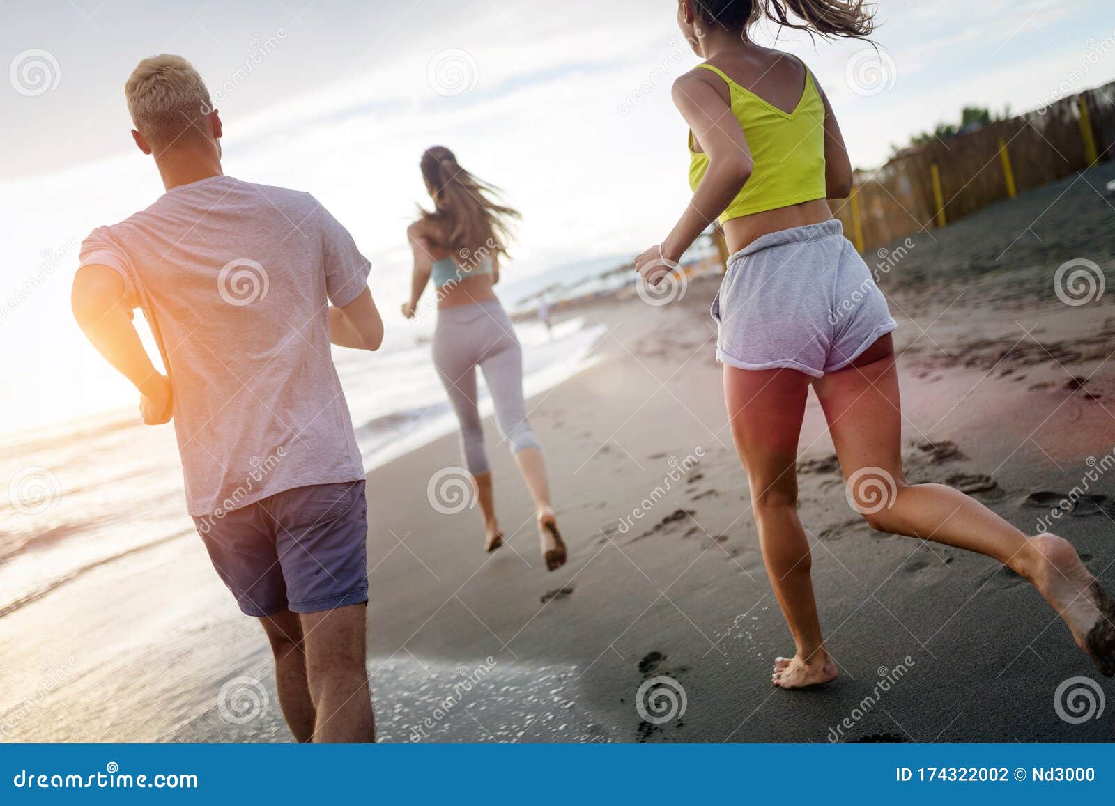 Group of Sport People Running on the Beach Stock Photo - Image of ...