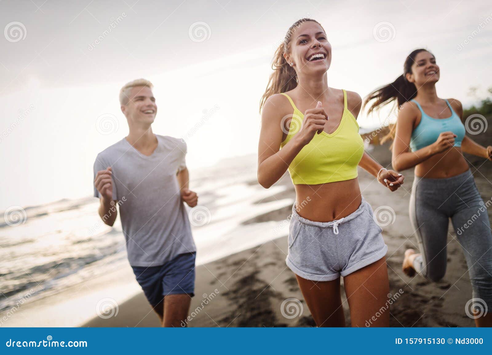 Group of Sport People Running on the Beach Stock Photo - Image of ...
