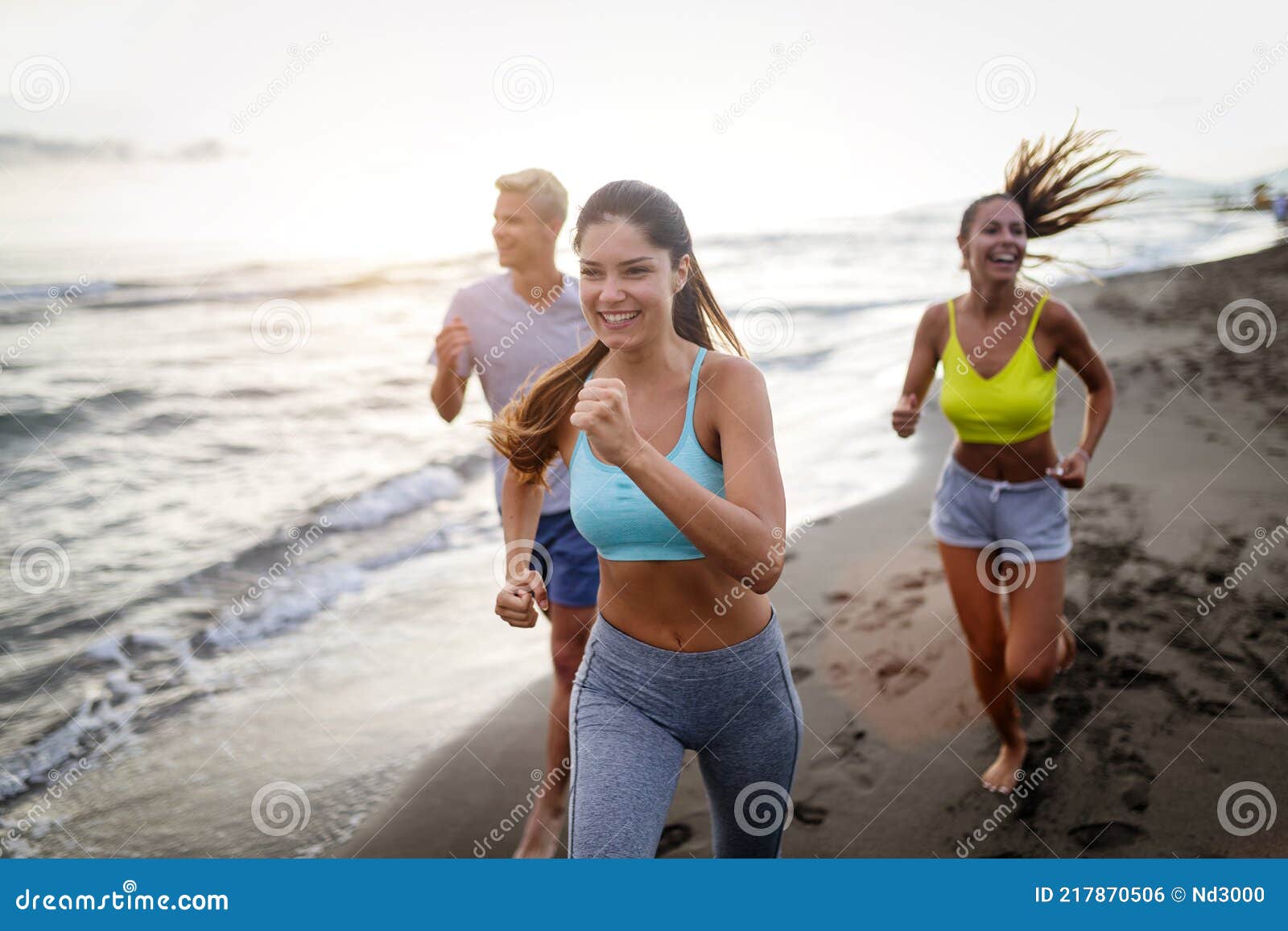Group of Sport People Running on the Beach Stock Photo - Image of ...