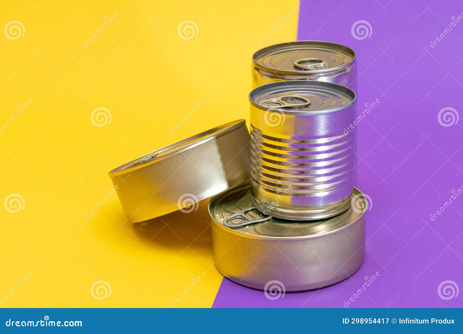 A Group of Stacked Tin Cans with Blank Edges on Split Yellow and Violet ...