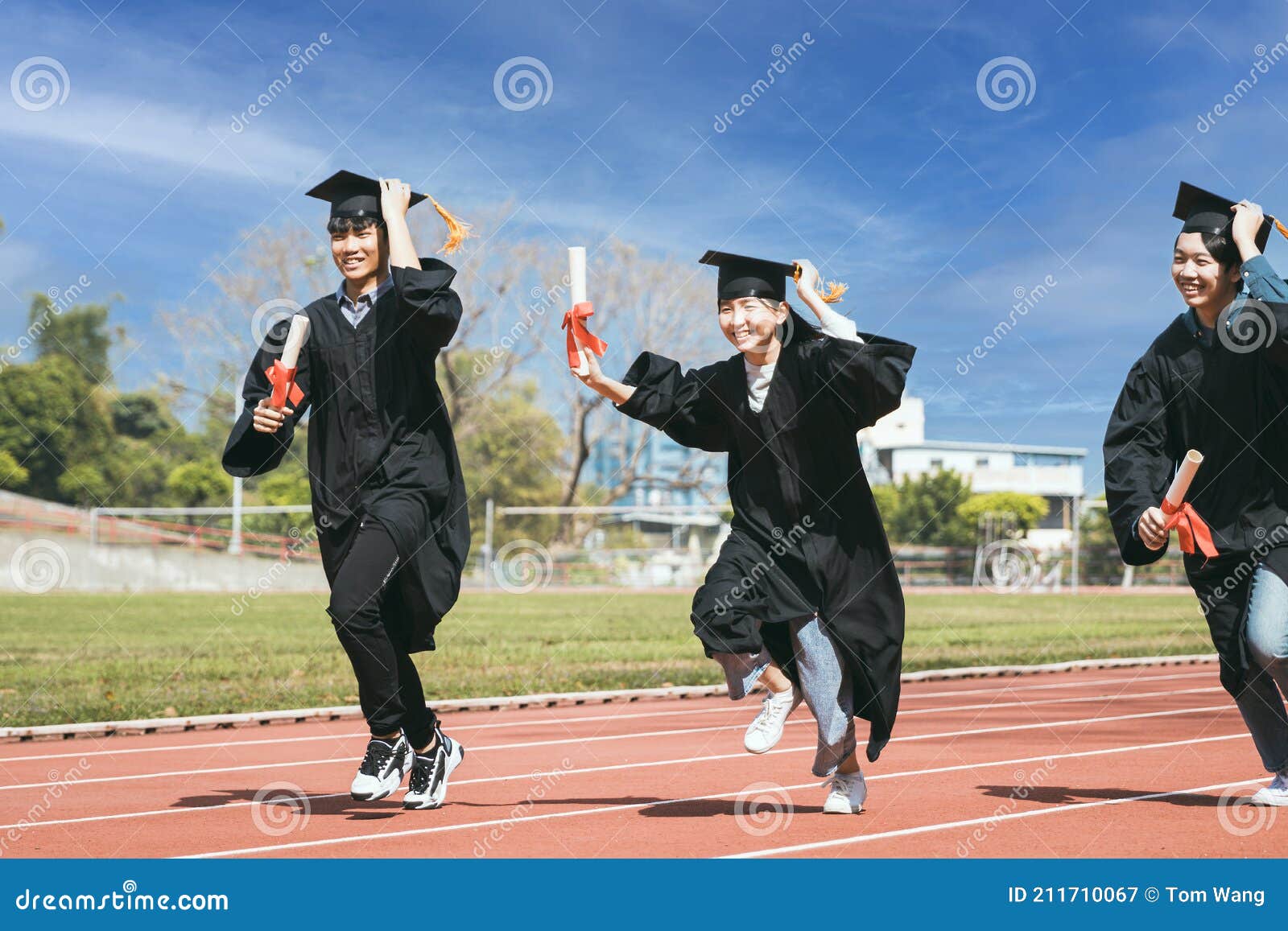 Group of Students Celebrating Graduation and Running on the Track Stock ...