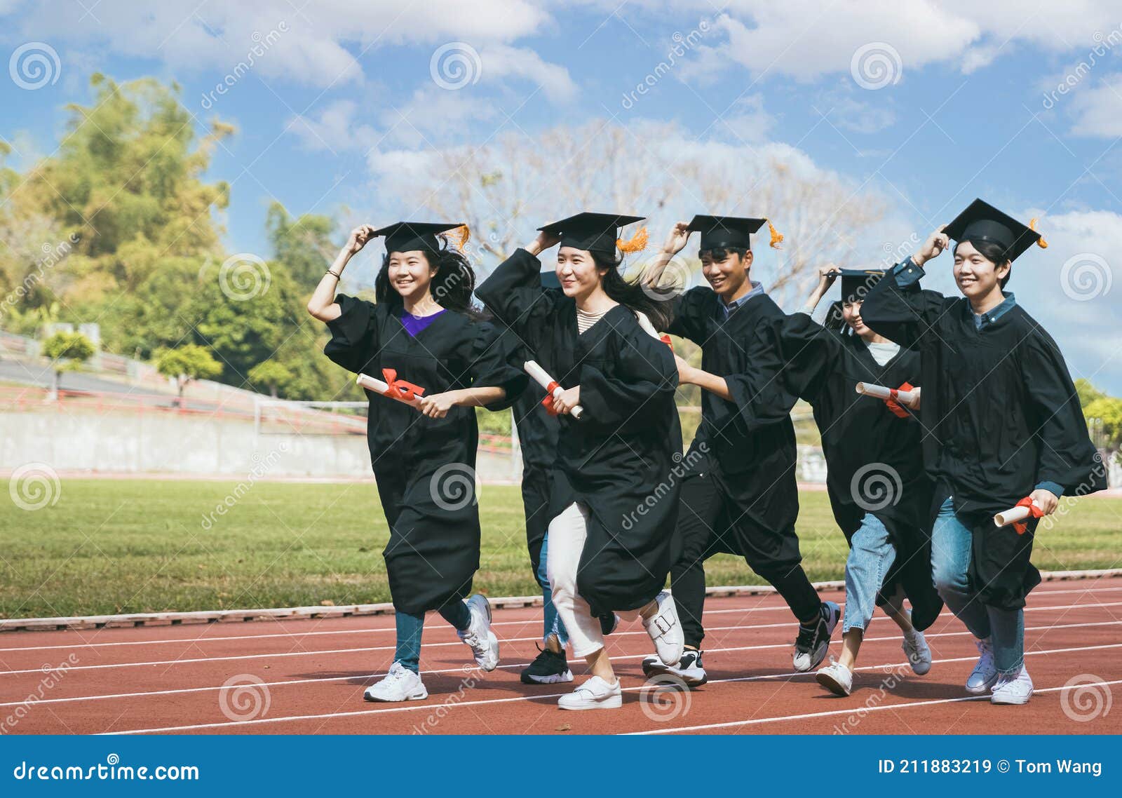 Group of Students Celebrating Graduation and Running on the Track Stock ...