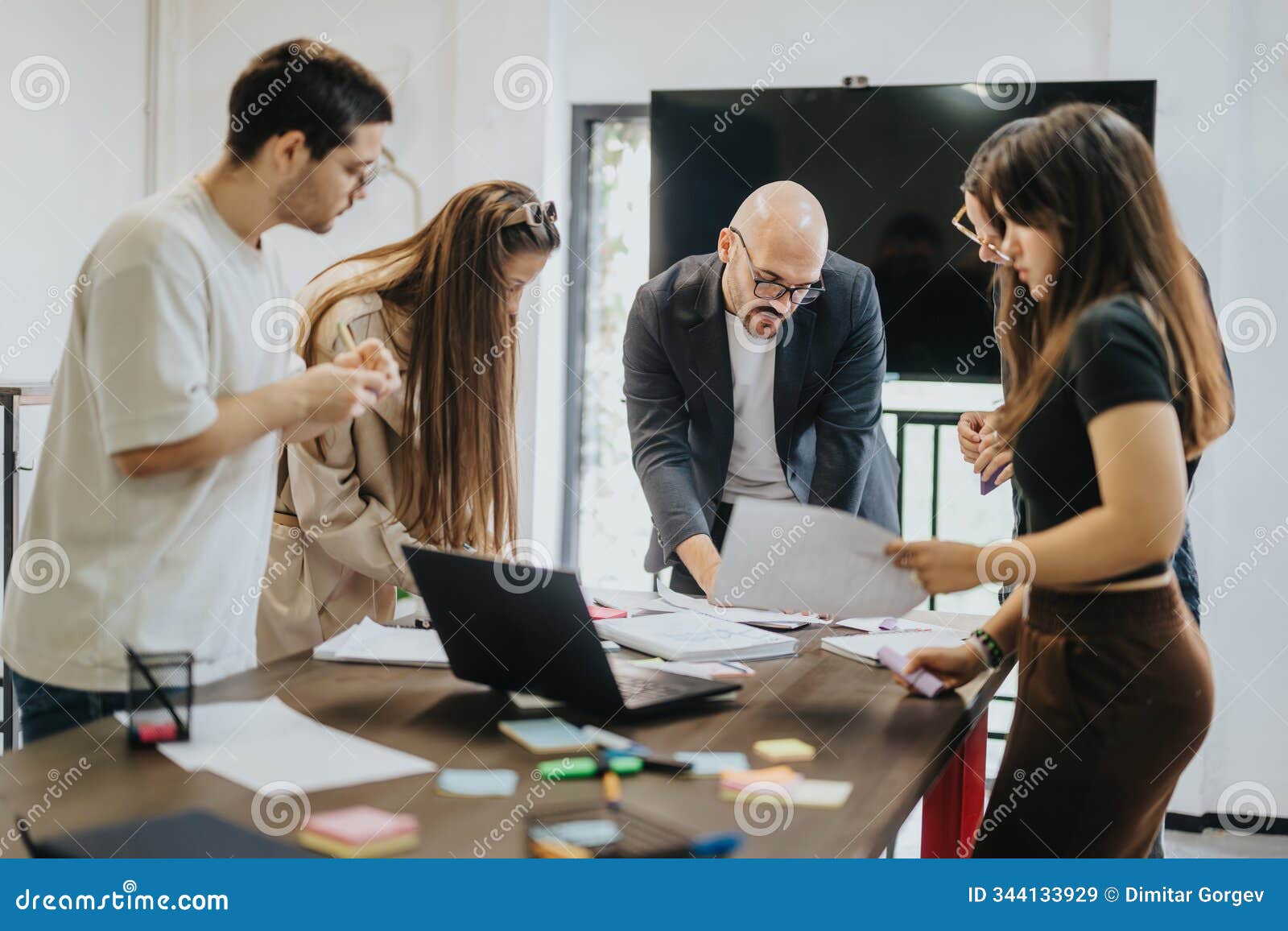 Students and Professor Collaborating on a Project in a Modern Classroom ...