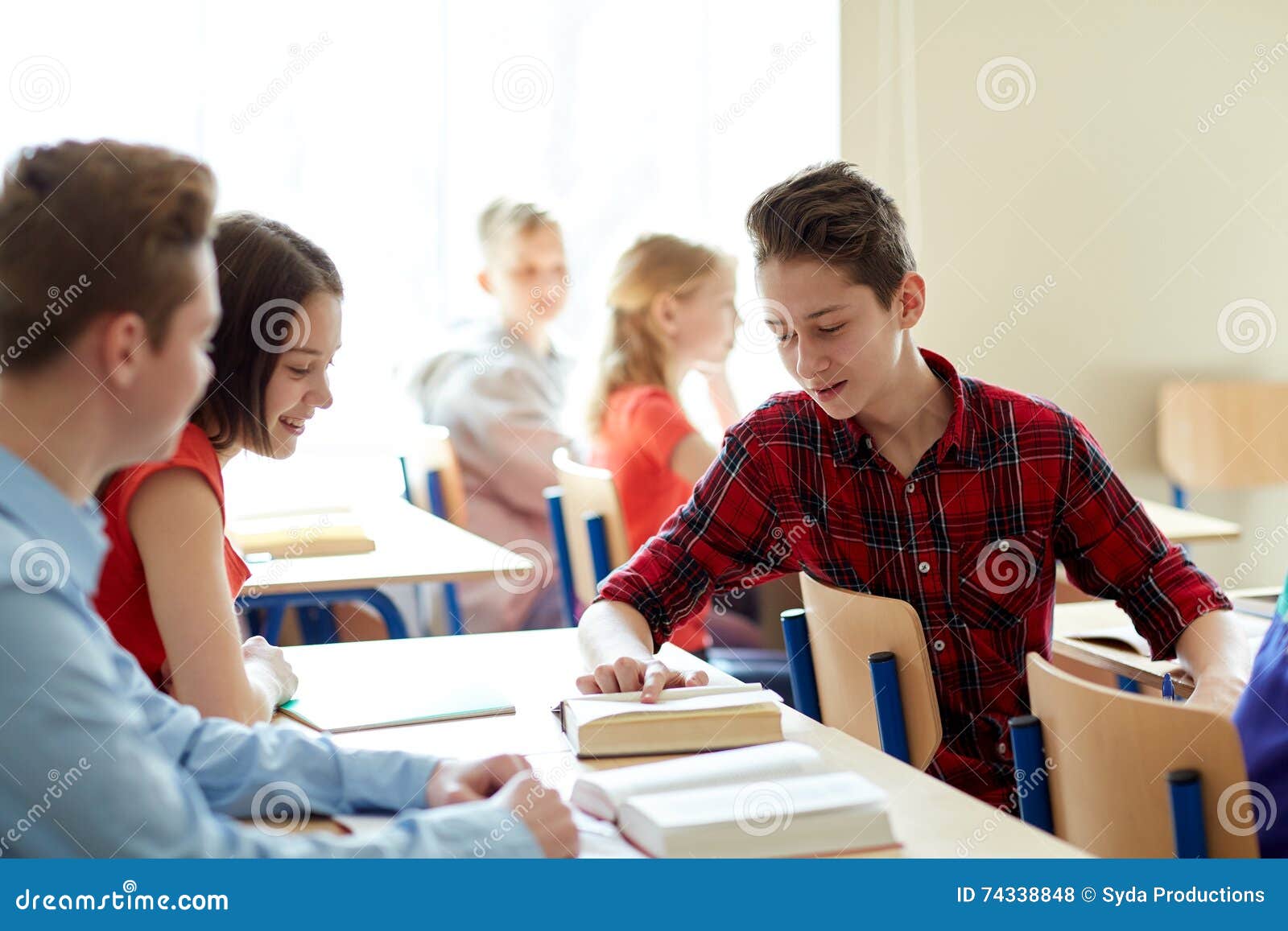 Group of Students Discussing Book at School Lesson Stock Photo - Image ...