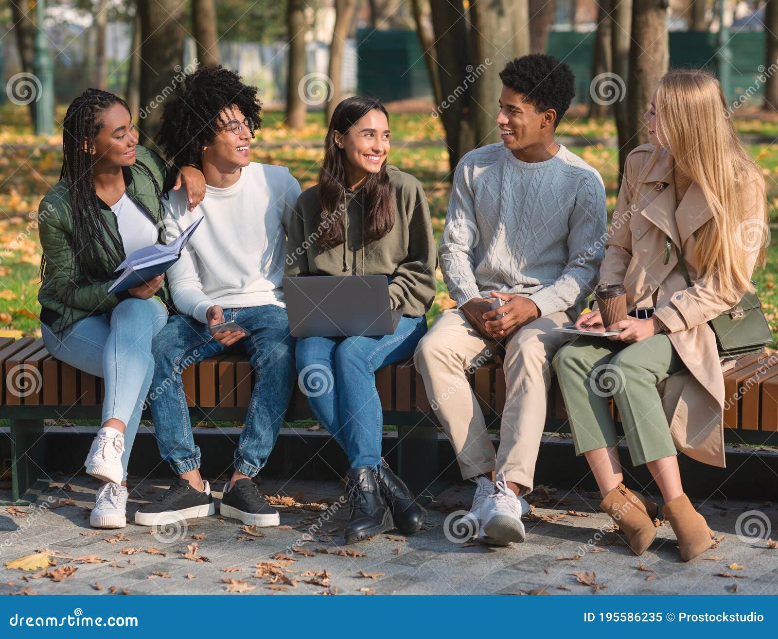 Group of Students Discussing Project, Sitting in Park Stock Image ...