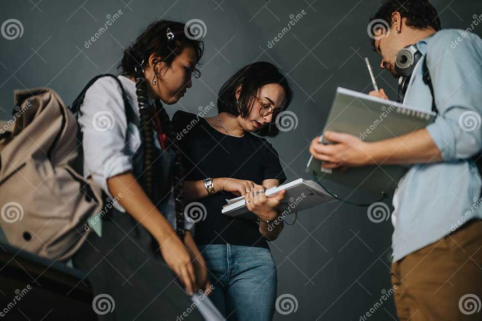 Group of Students Discussing Schoolwork in the Hallway between Classes Stock Image - Image of ...