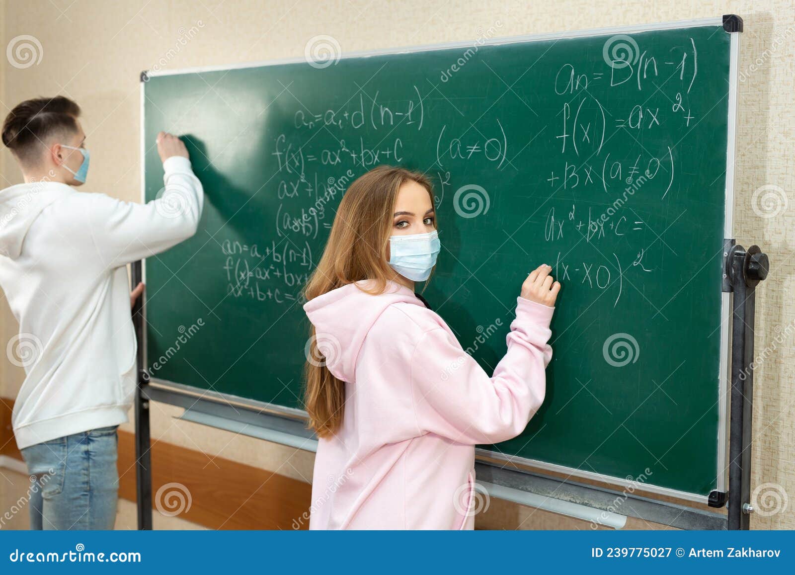 Group of Students with Face Mask Writing on the Board in the Classroom ...