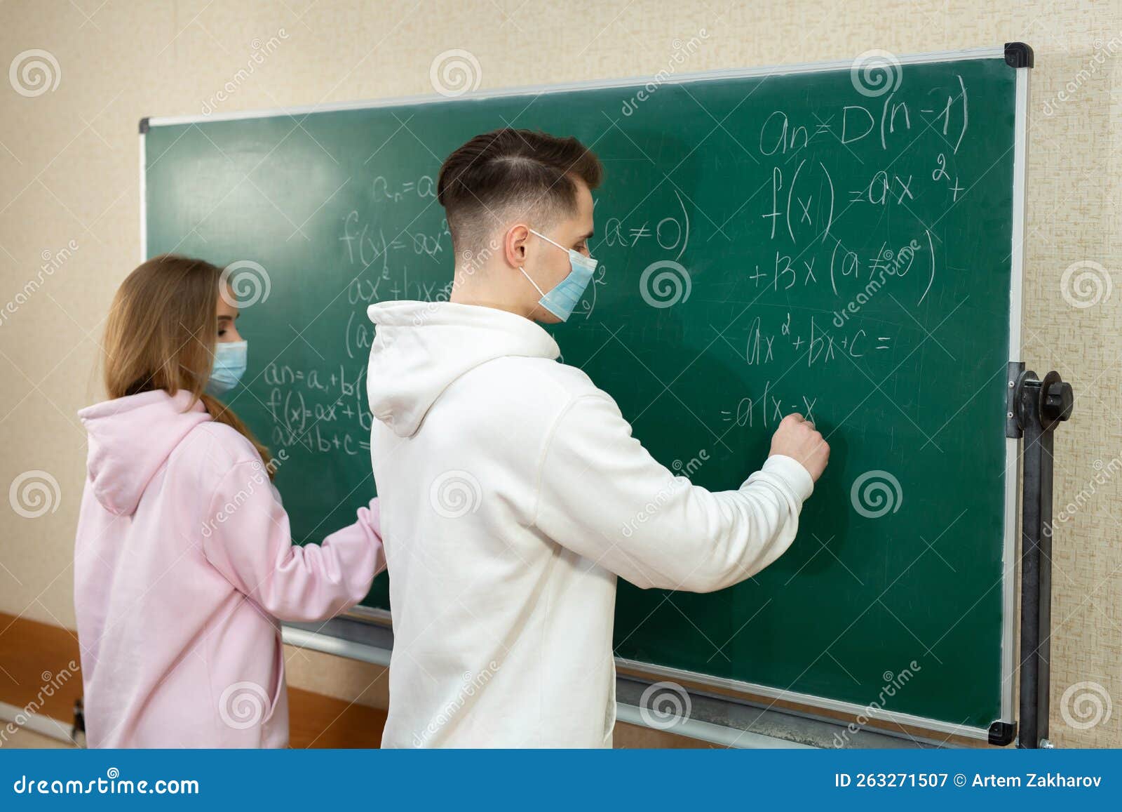 Group of Students with Face Mask Writing on the Board in the Classroom ...